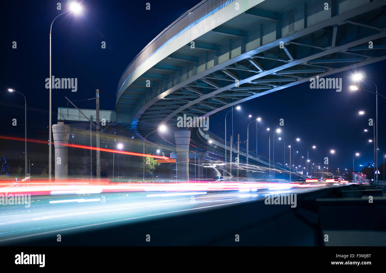 Overpass and light trails at night on the illuminated highway Stock ...
