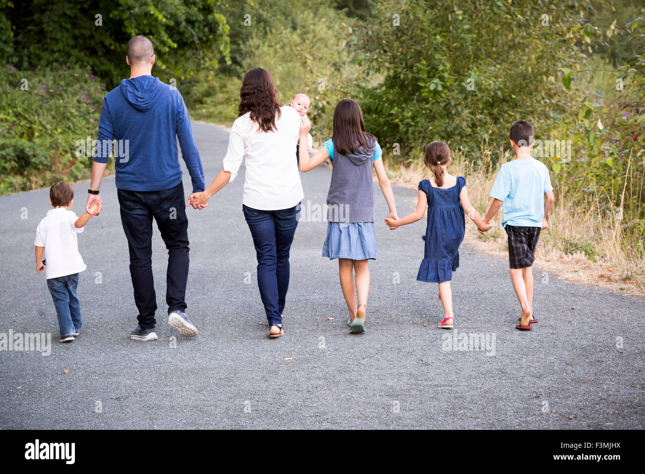 Woman holding hands two children hi-res stock photography and images ...