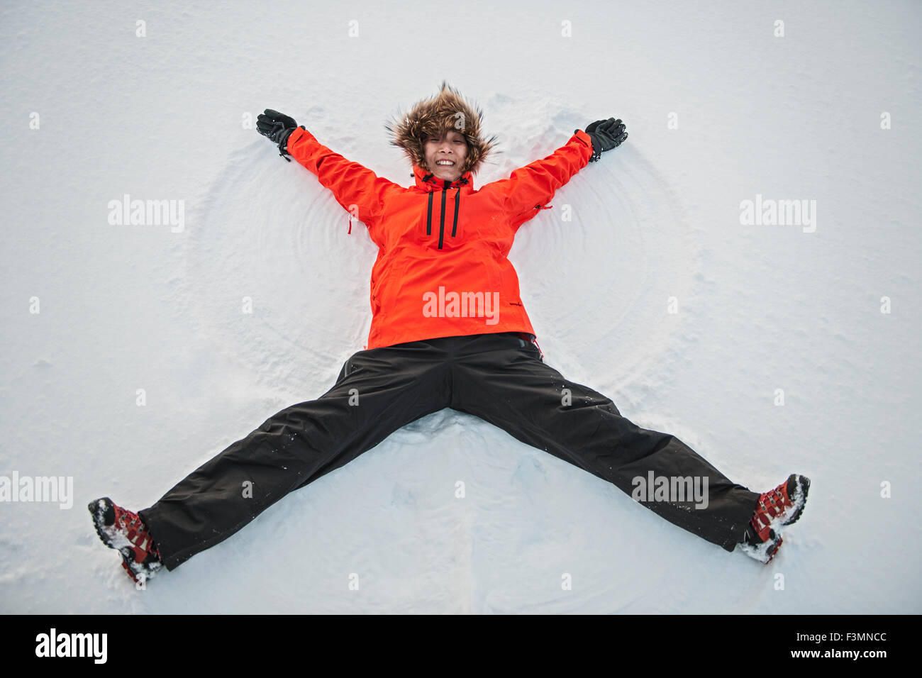 woman making a snow angel in Iceland Stock Photo - Alamy
