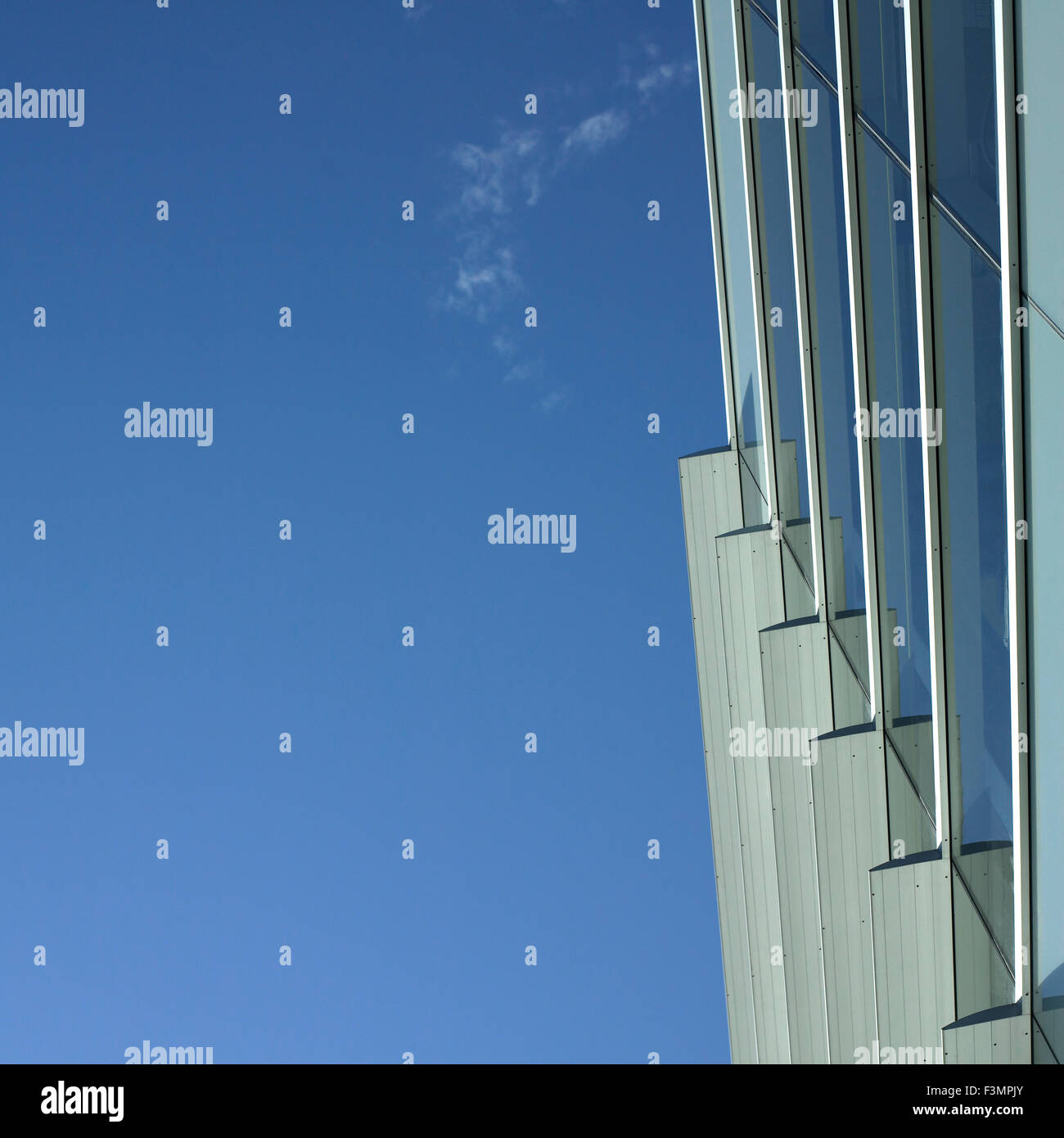 Modern glass and metal building with blue sky Stock Photo - Alamy