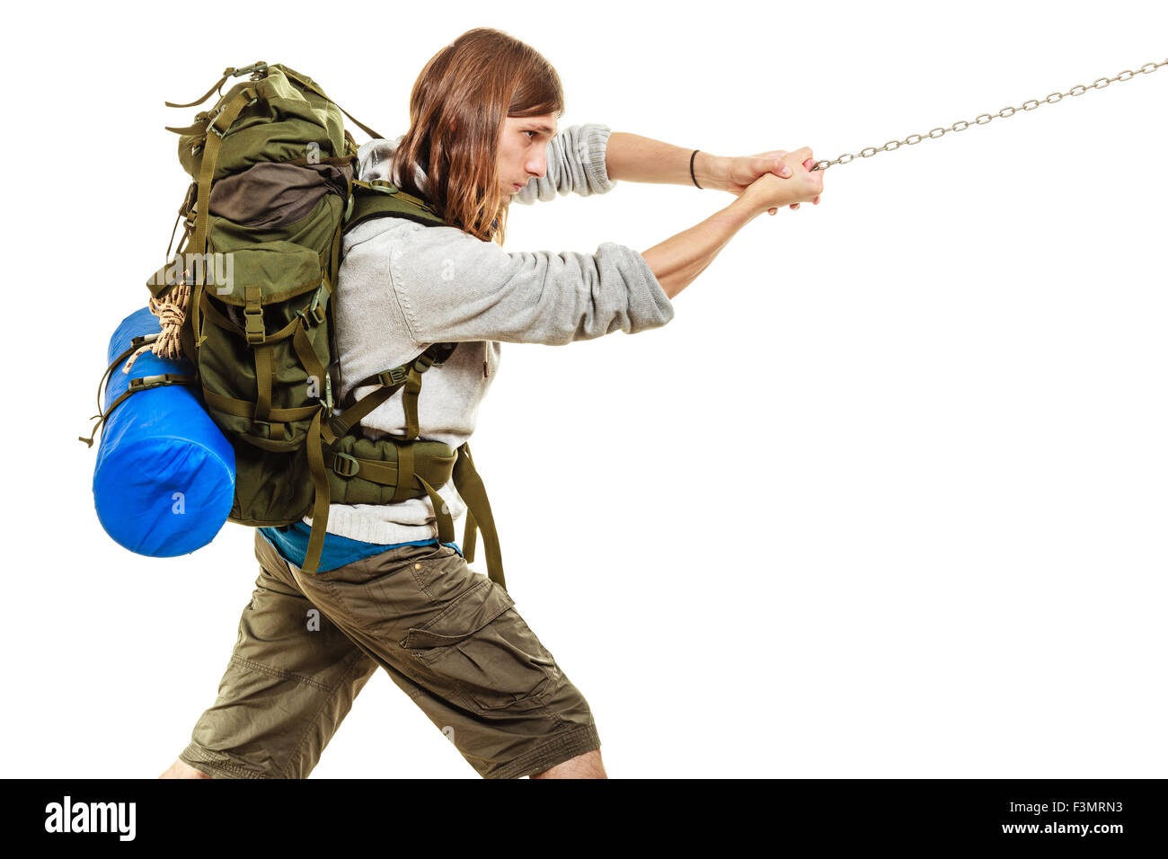 Backpacker mountaineer hiking climbing rock mountain. Young man ...