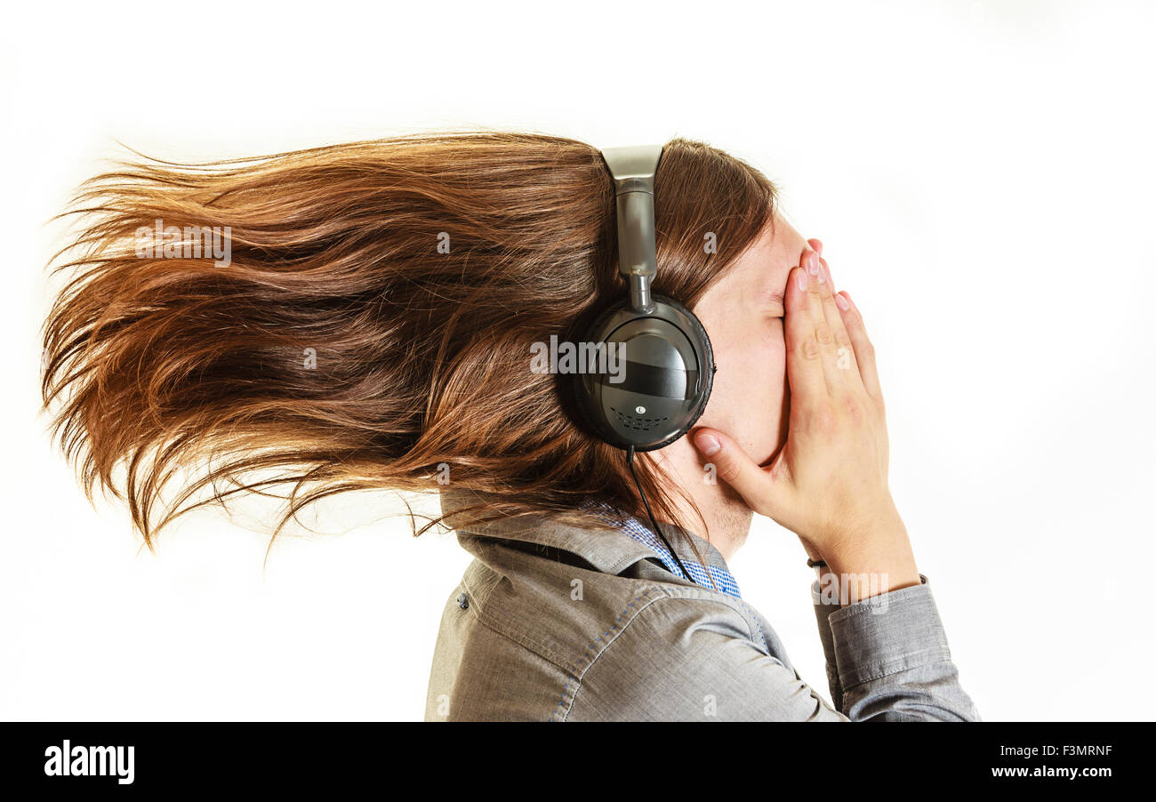 Passionate music lover with long hair flying. Young man listening ...