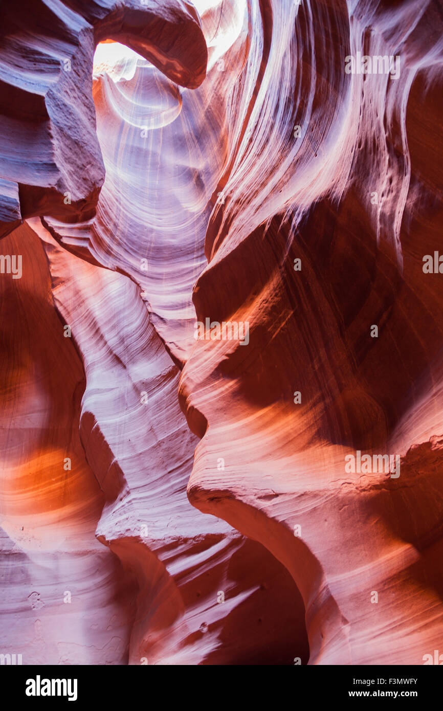 Rocks striped in purple, pink and red from water inside Upper Antelope ...