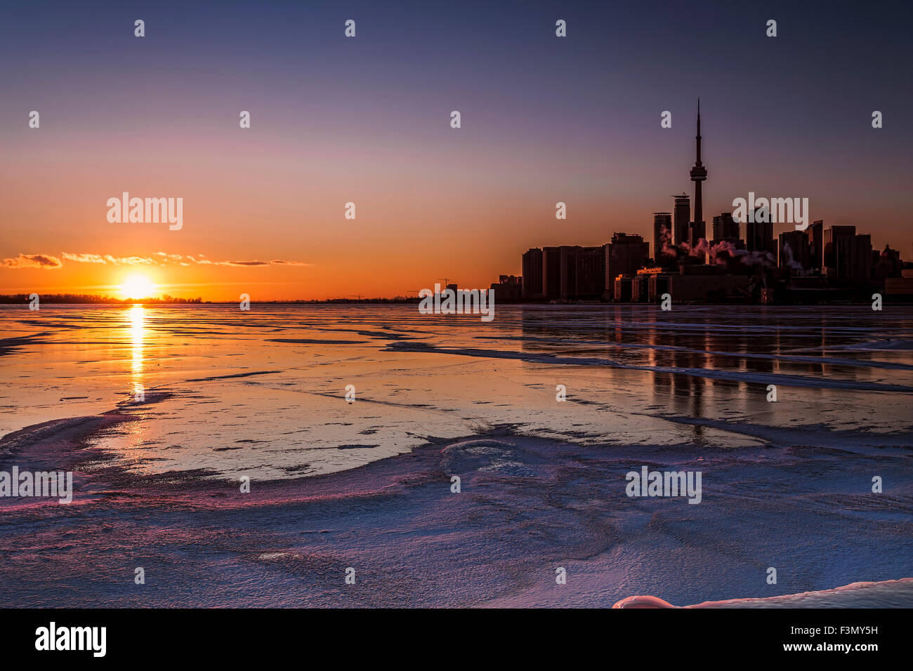 A gorgeous winter sunset over frozen Lake Ontario, with Toronto skyline ...