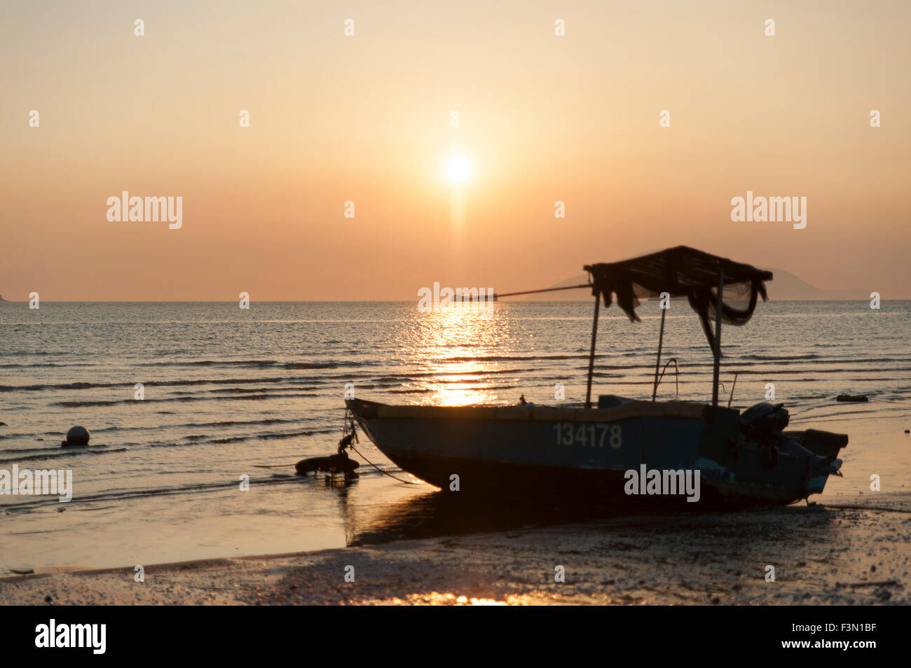Boat seat on a beach with sunset Stock Photo - Alamy