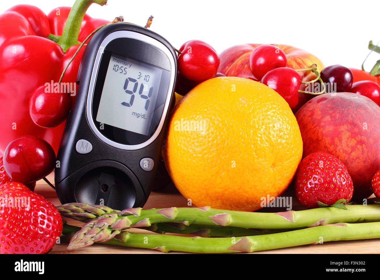 Glucose meter with fresh ripe fruits and vegetables, concept of ...