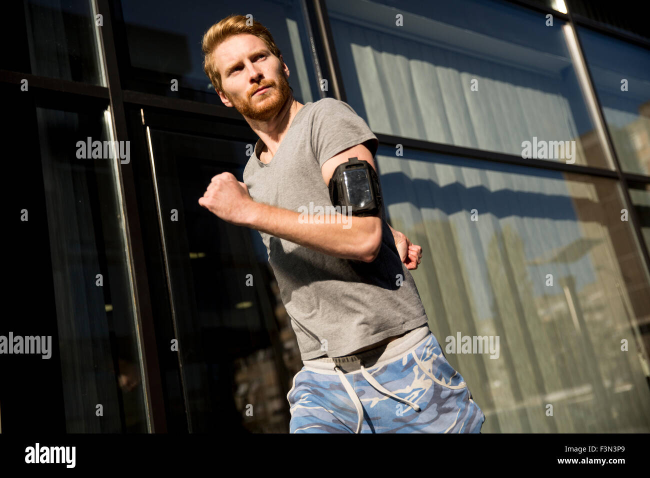 Young man running in the urban area Stock Photo - Alamy