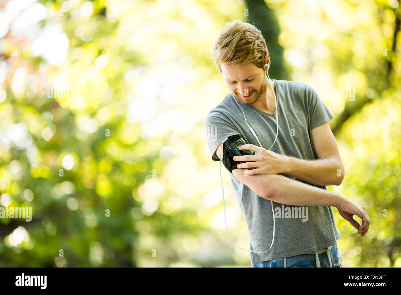 Young man running in the autumn park Stock Photo - Alamy