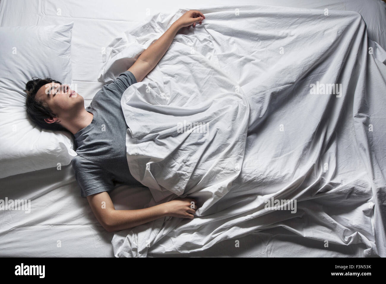 Man asleep in a bed Stock Photo - Alamy
