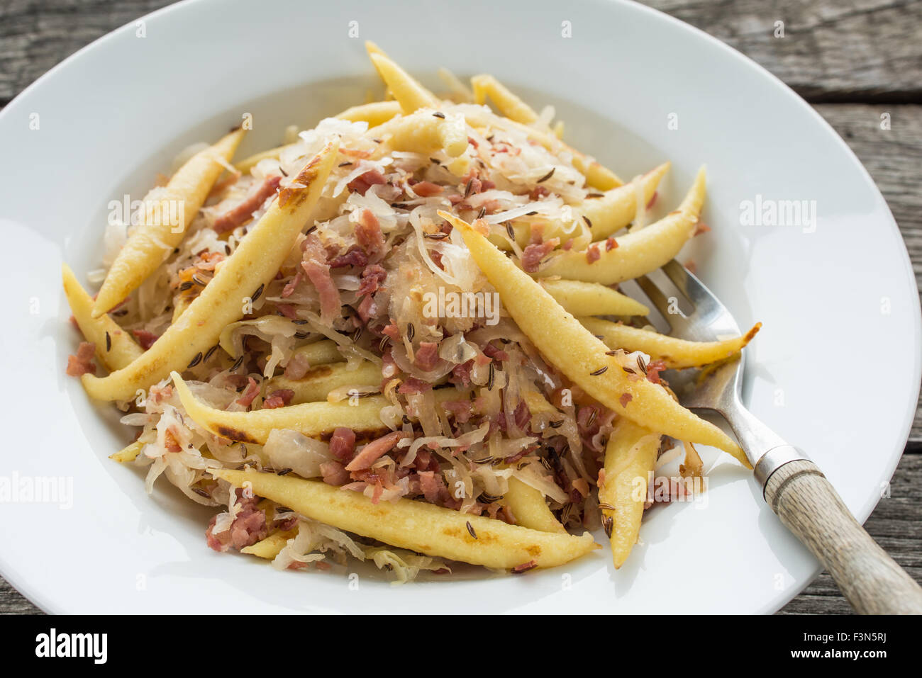 Finger shaped potato dumplings with sauerkraut, caraway and bacon Stock ...