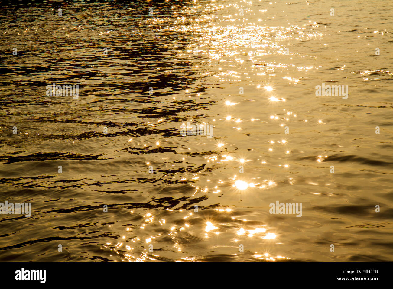 Sun reflected in water Stock Photo - Alamy