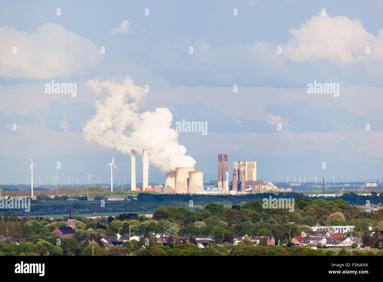 Long distance view over rural landscape to a steaming coal-fired power ...