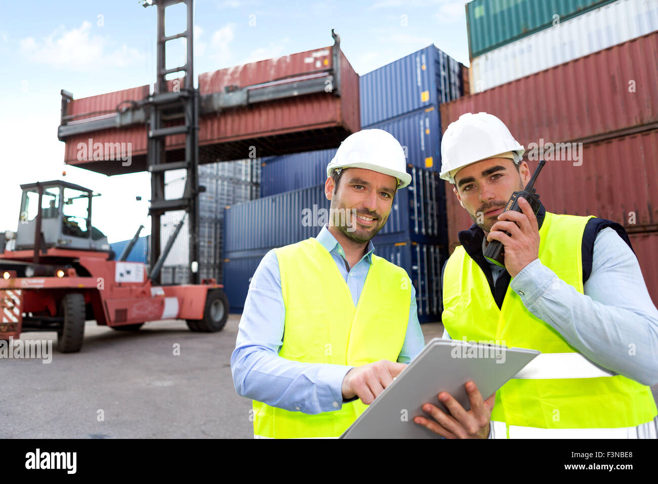 View of a Dock worker and supervisor checking containers data Stock ...