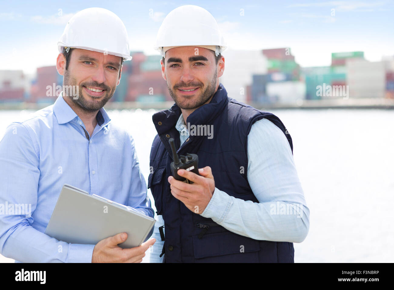 View of a Dock worker and supervisor checking containers data Stock ...