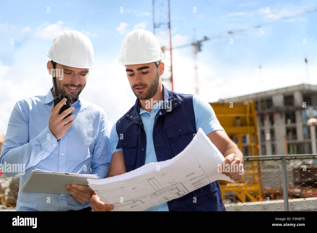 View of an Engineer and worker checking plan on construction site Stock ...