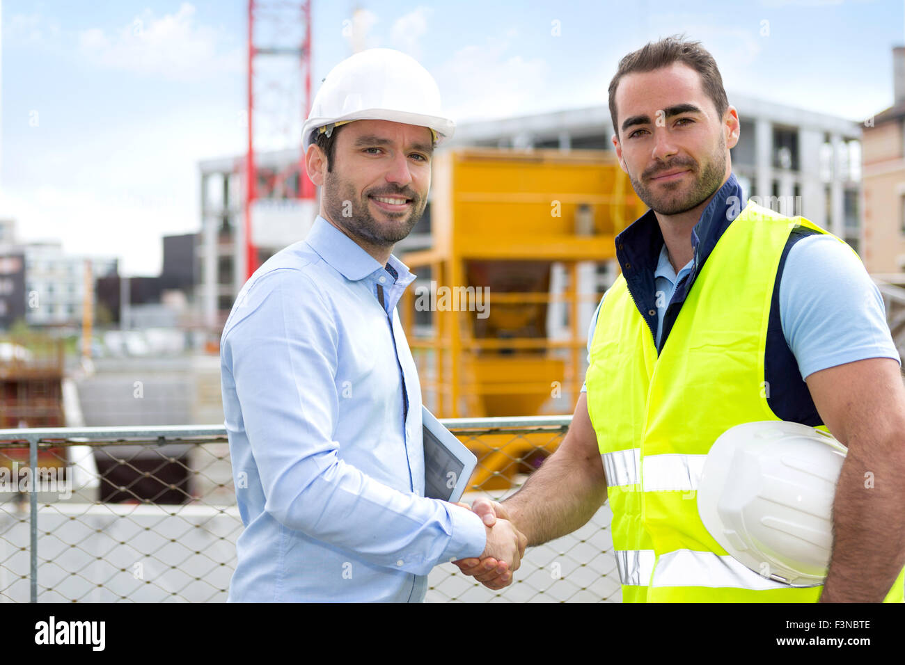 View of an architect and worker handshaking on construction site Stock ...