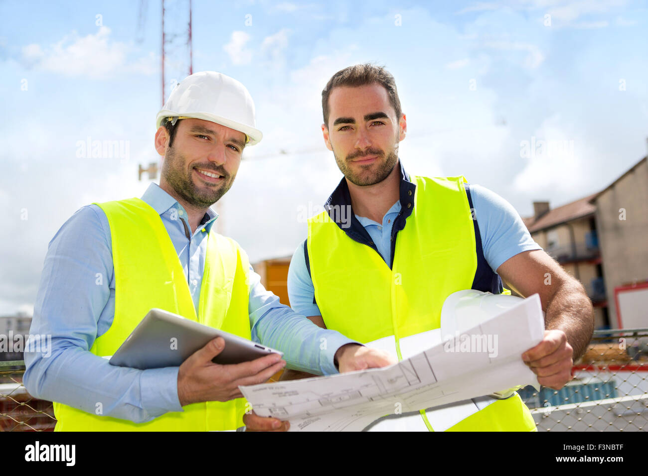 View of an Engineer and worker checking plan on construction site Stock ...