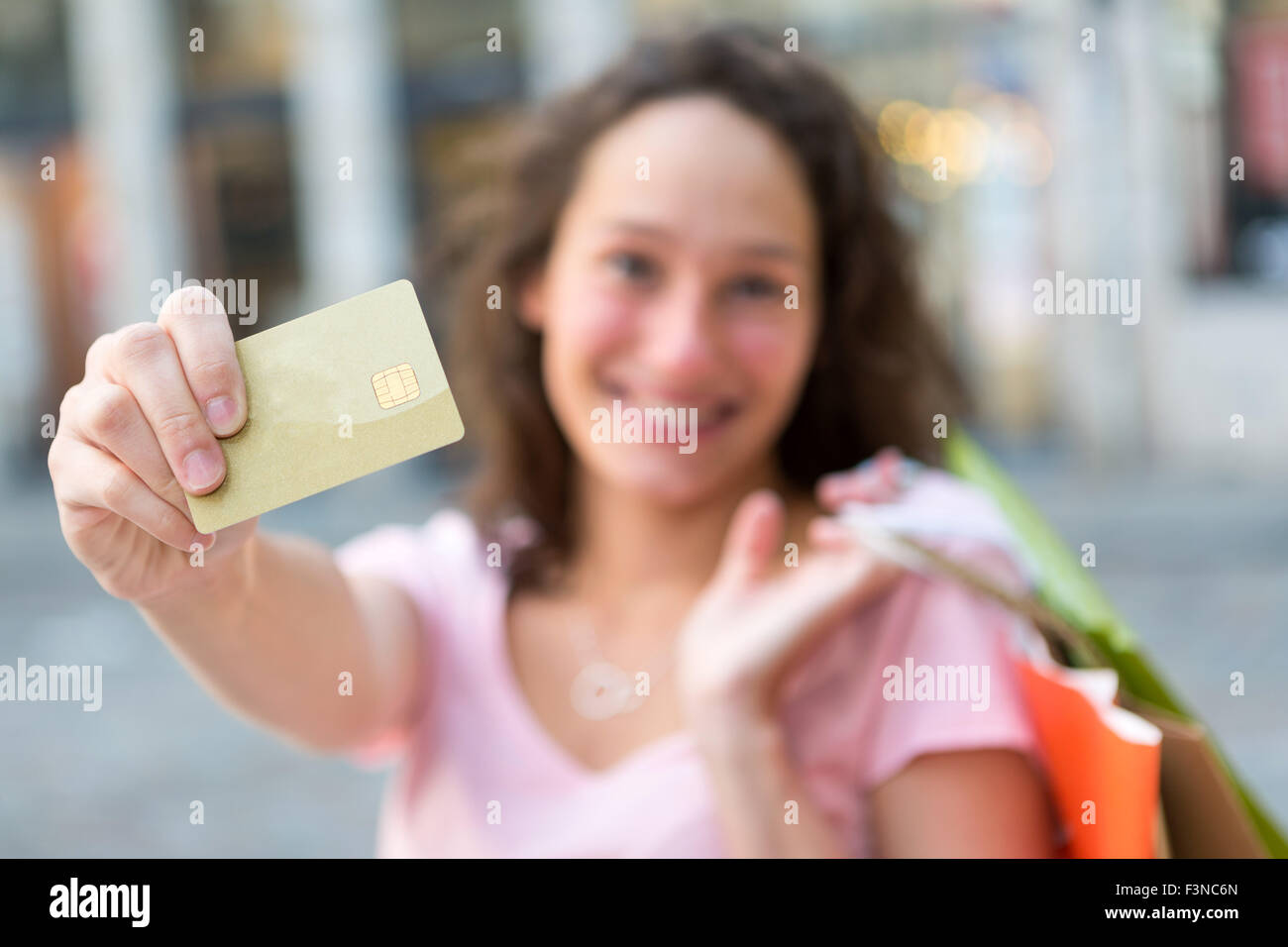 View of a Young attractive woman handling credit card during shopping ...