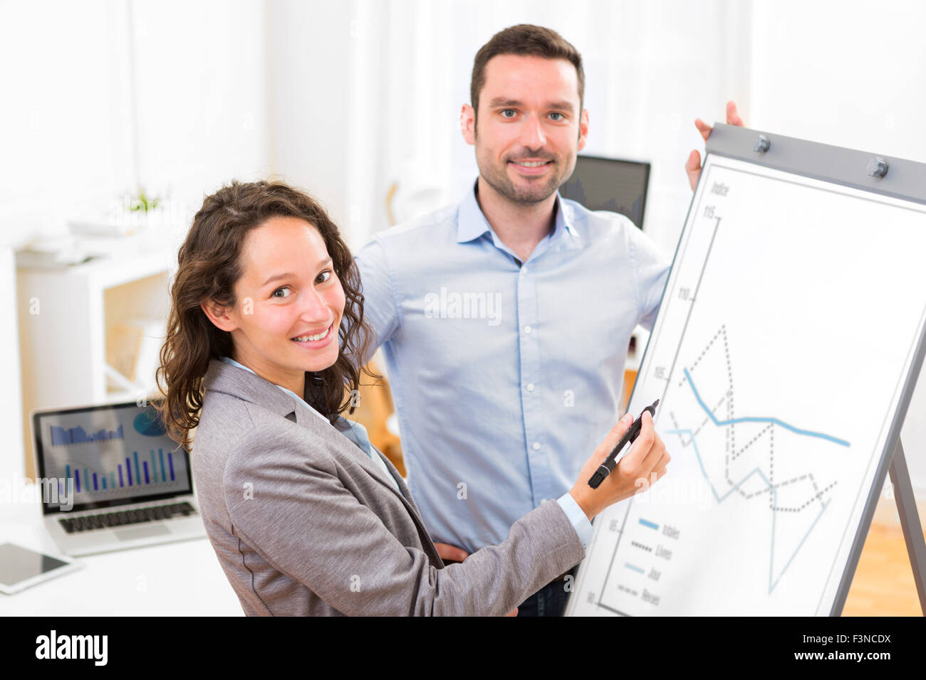 View of Business man and woman analysing stats on a paperboard Stock ...