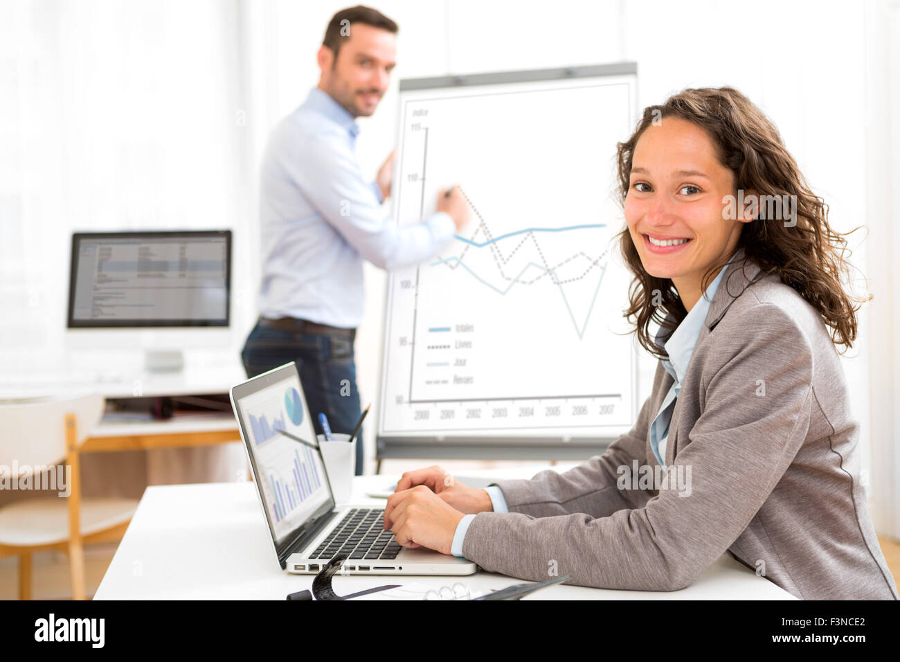 View of a Business man and woman analysing stats while doing video ...