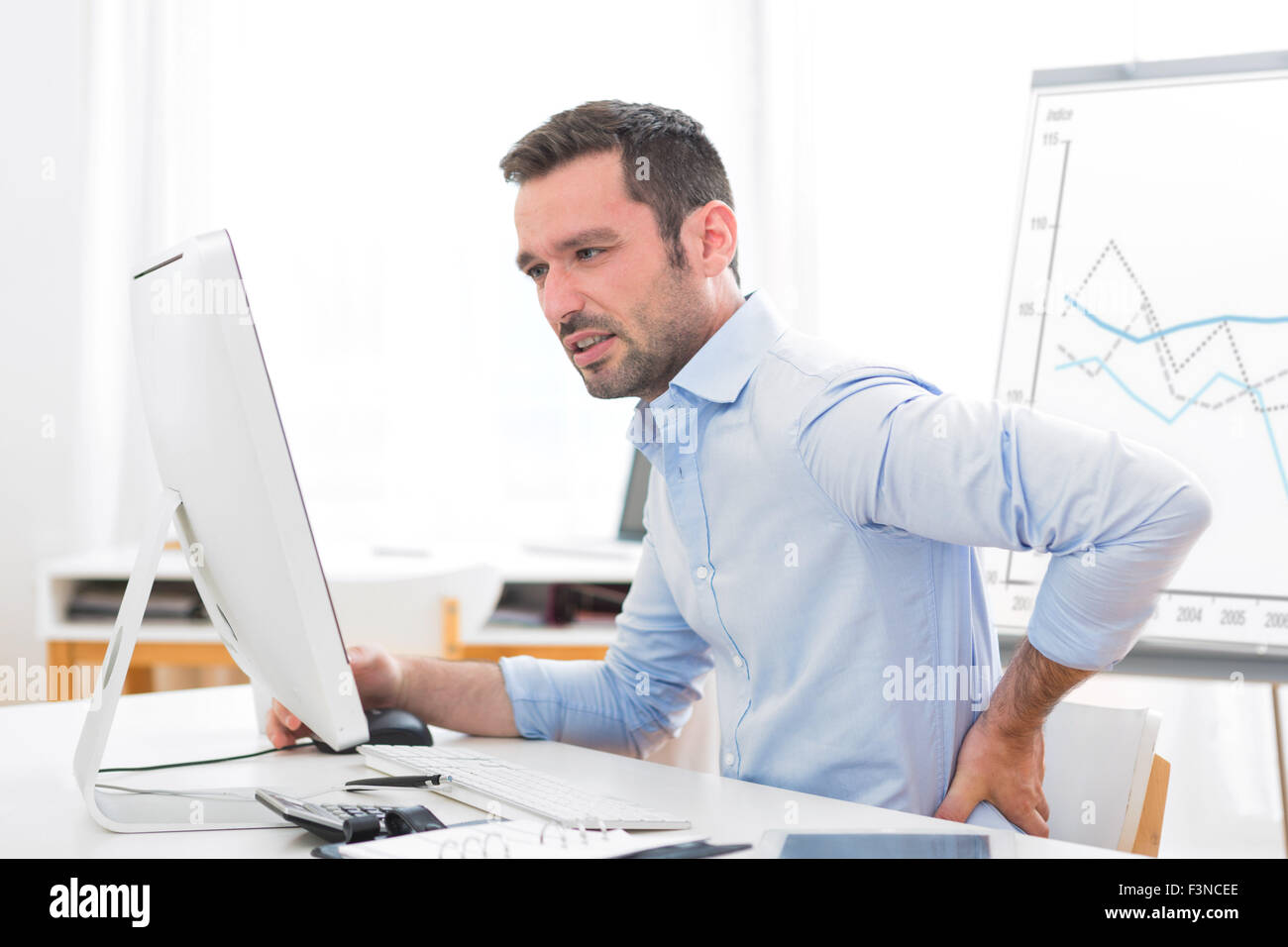 View of a Young attractive business got backache because of burn out ...