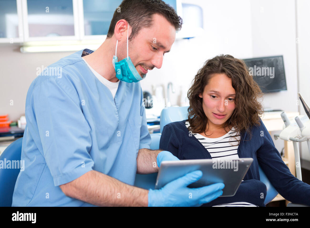 View of a Young attractive woman scared to being cured by a dentist ...