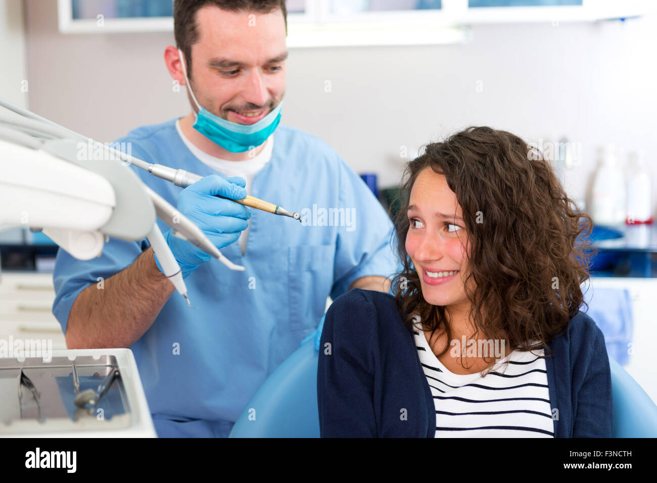 View of a Young attractive woman being cured by a dentist Stock Photo ...