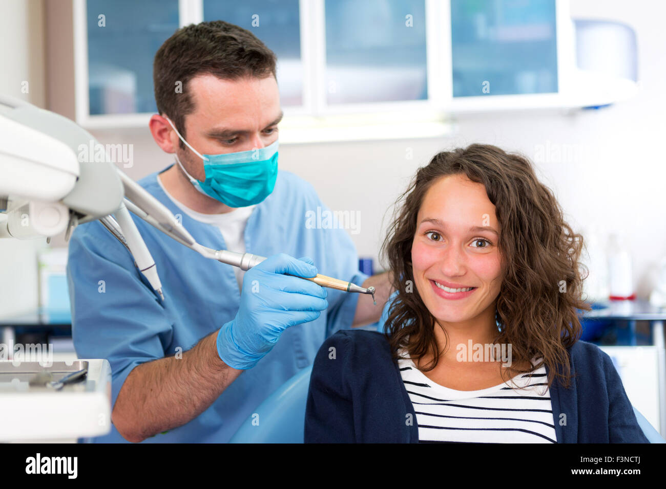 View of a Young attractive woman being cured by a dentist Stock Photo ...