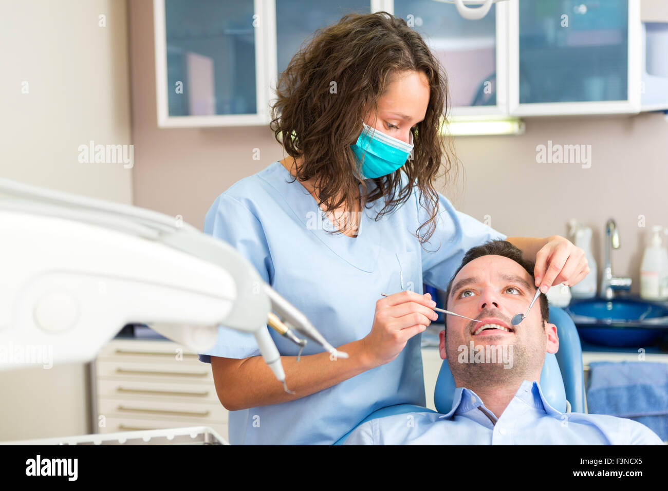 View of a Young attractive man being cured by a dentist Stock Photo - Alamy