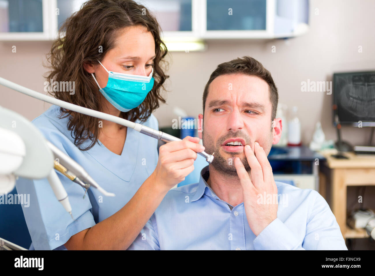 View of a Young attractive man scared to being cured by a dentist Stock ...