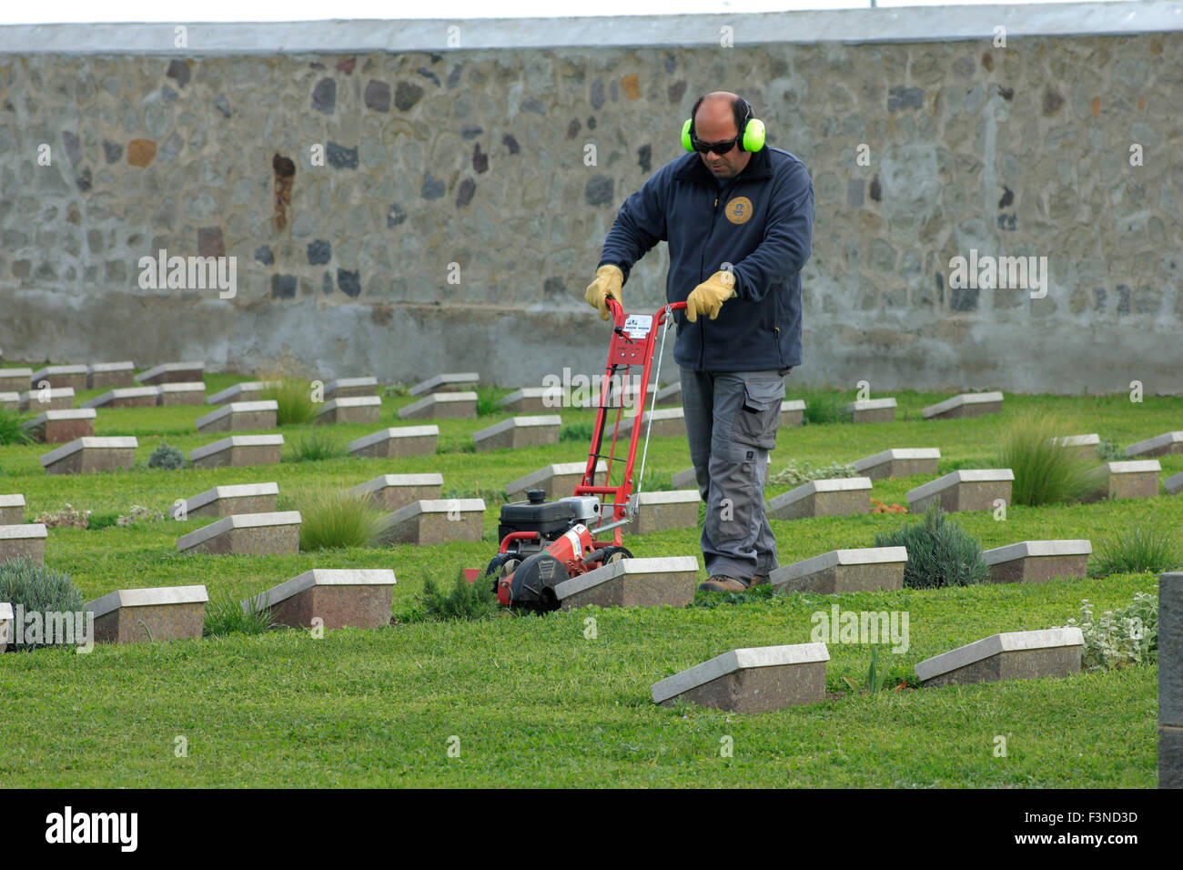 The gardening supervisor of CWGC on Lemnos, mowing the lawn of Plot II ...
