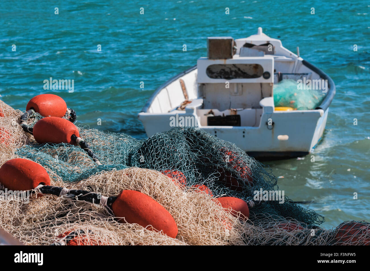 Fishing nets are on the boat moorage ready for loading at fishing boat ...