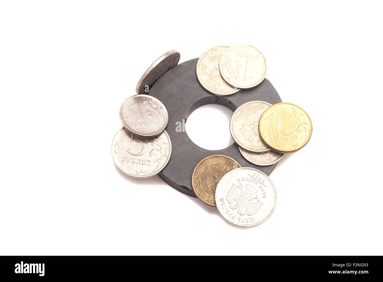 Coins attracted by magnet Stock Photo - Alamy