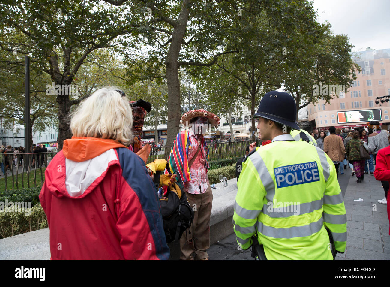 Leicester Square, UK,10th October 2015, Police chat to Zombies in ...
