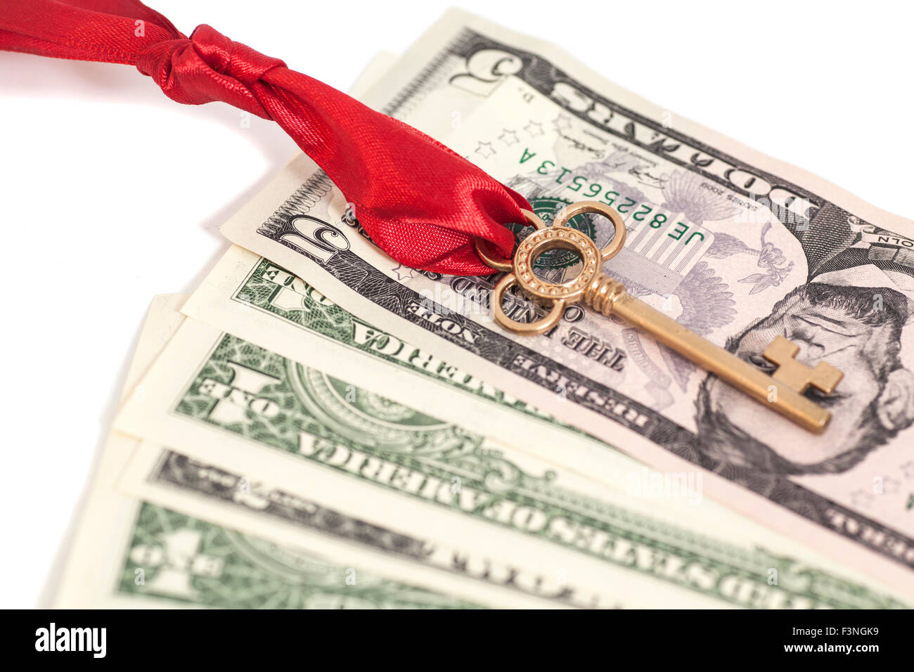 Golden Key With Bow And Dollars isolated Stock Photo - Alamy
