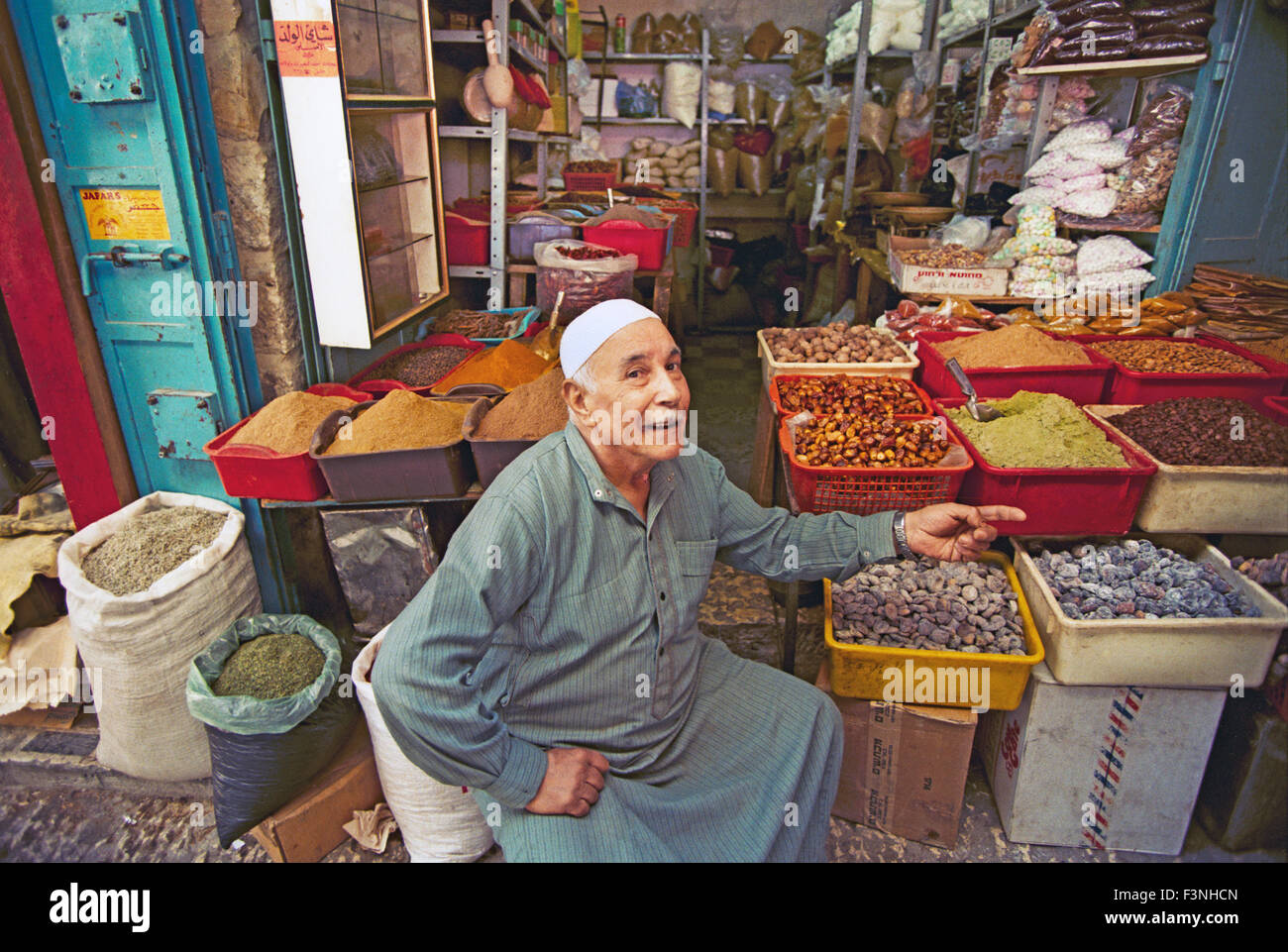 A Palestinian Arab selling dates and spices from a small shop in the ...