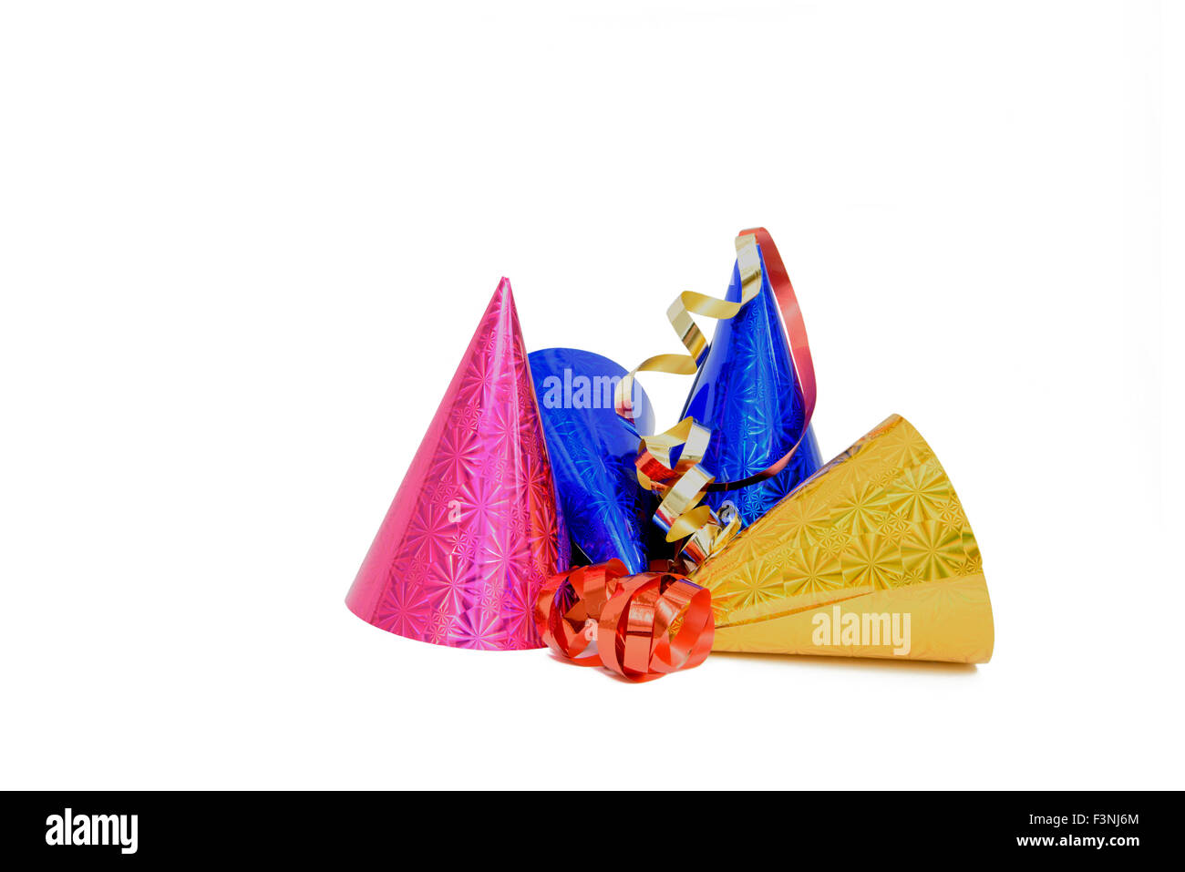 Pink, blue and gold metallic looking party hats. Isolated against a ...