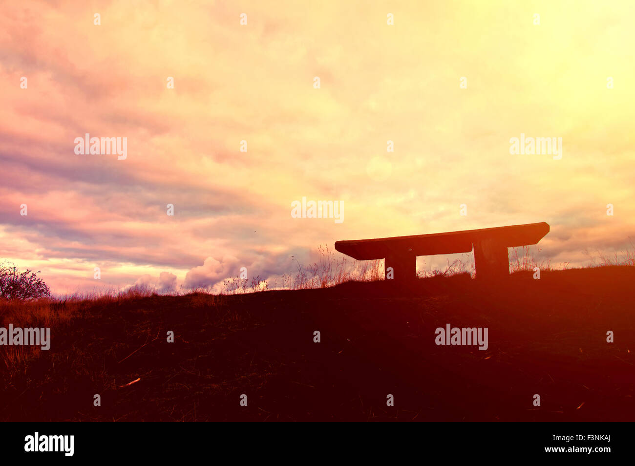 Bench and sundown. Alone bench at sunset Stock Photo - Alamy