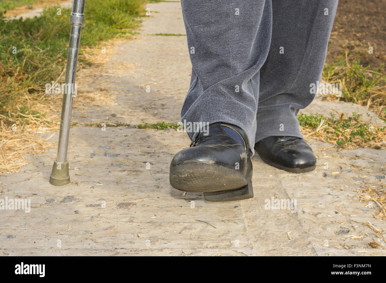 Man with walking stick doing hard step outdoor Stock Photo - Alamy