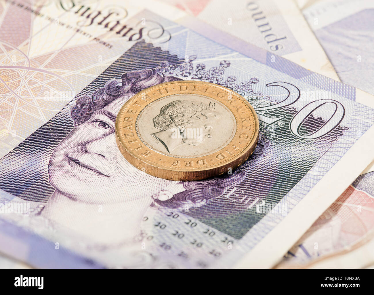 British pounds banknote of twenty and coin of two Stock Photo - Alamy