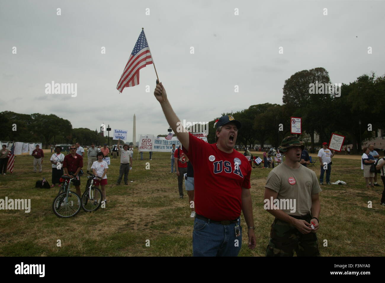 Man holding the American flag at a support military families supporters ...