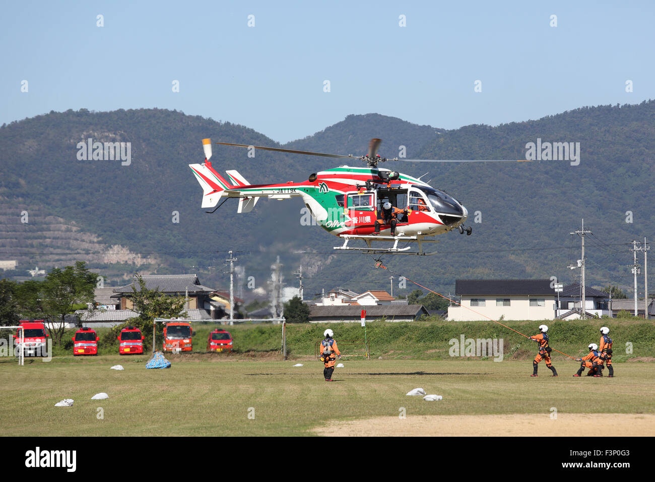 fireman works with a helicopter Stock Photo - Alamy