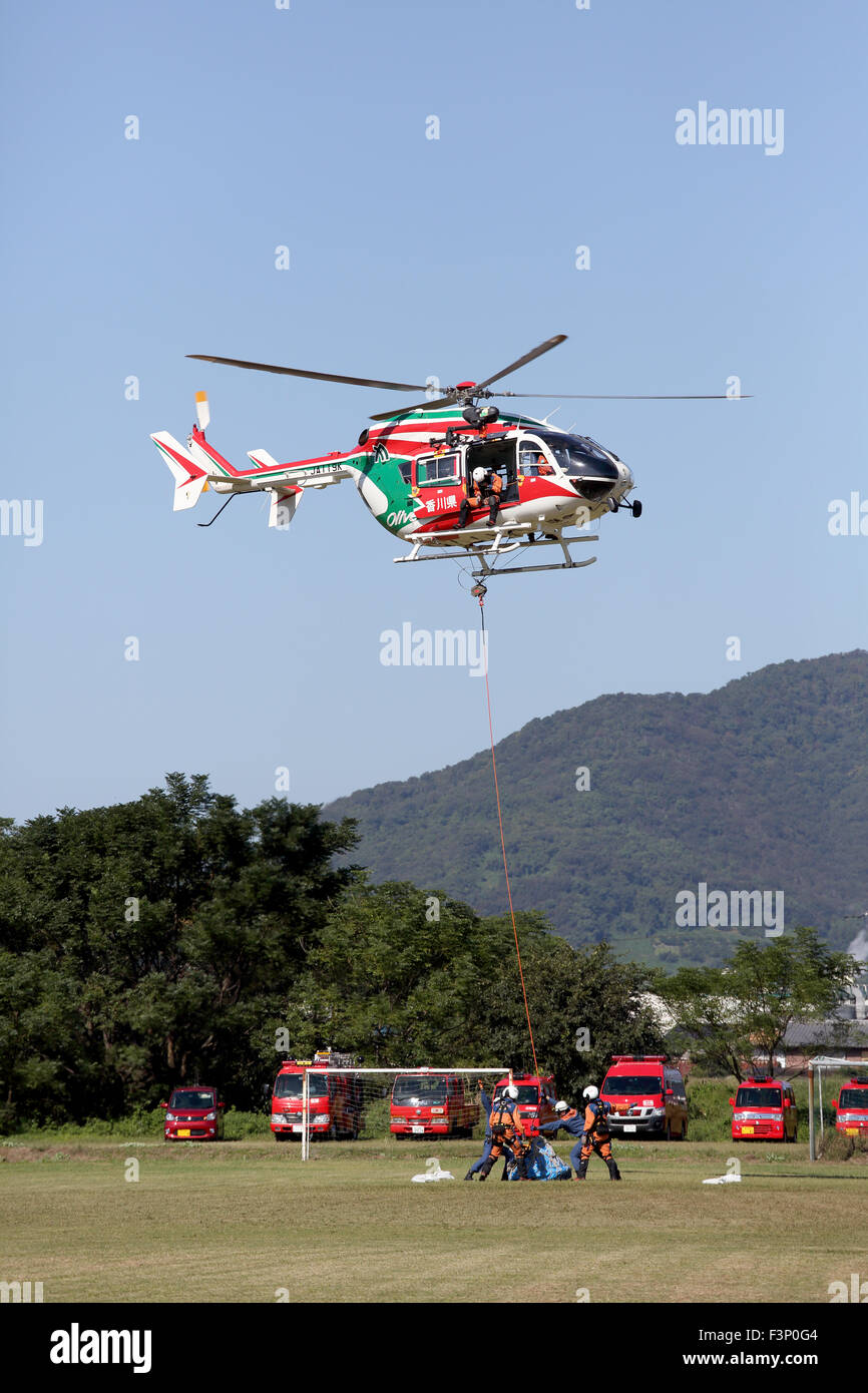 fireman works with a helicopter Stock Photo - Alamy