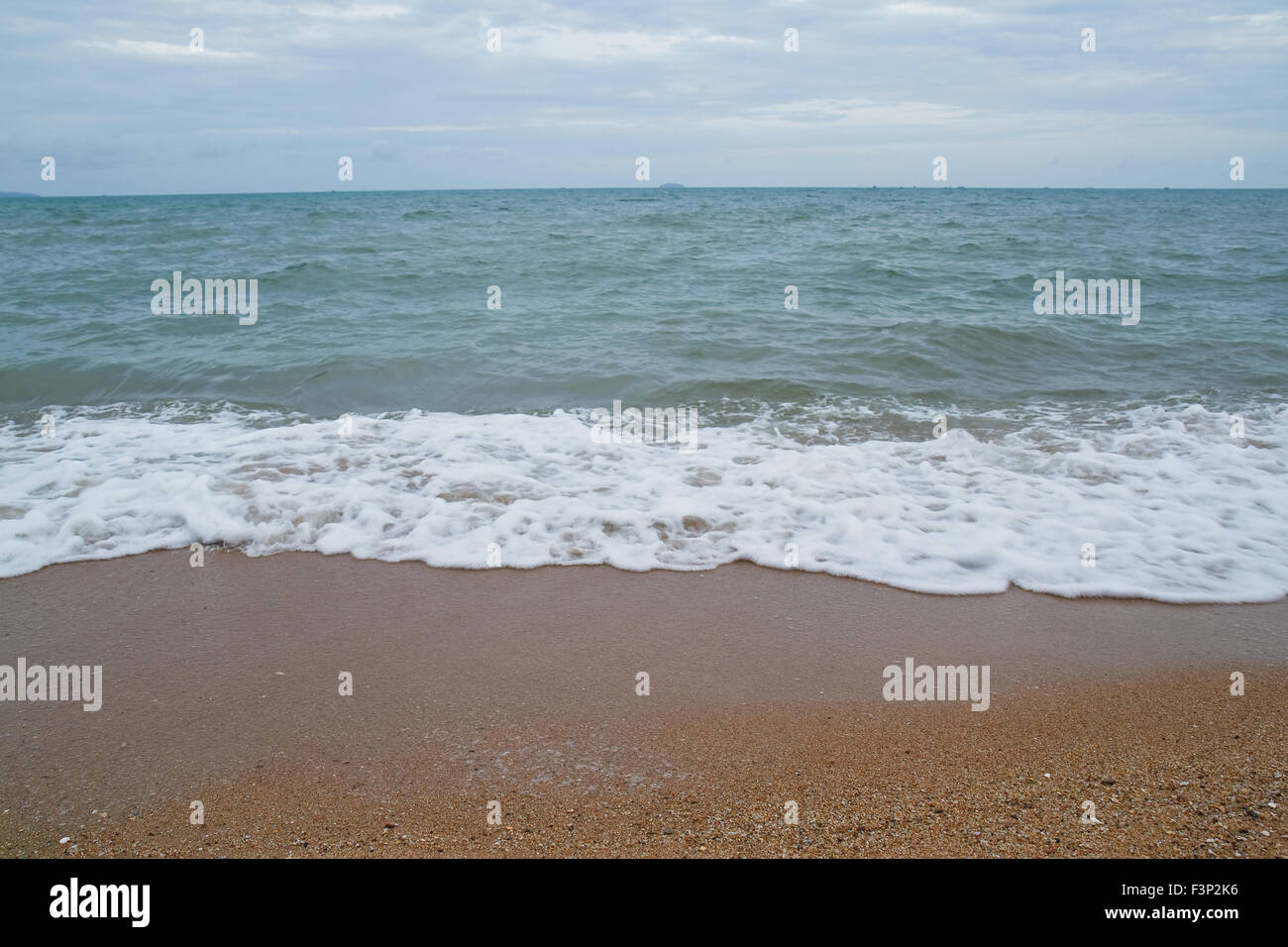 Sea wave over sand Stock Photo - Alamy