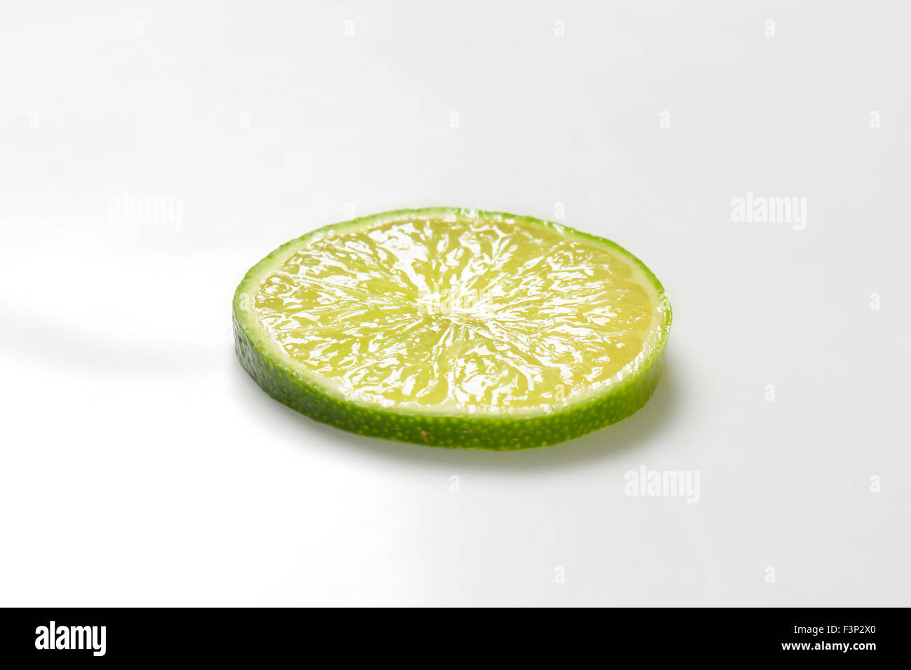 slice of lime on white background Stock Photo - Alamy