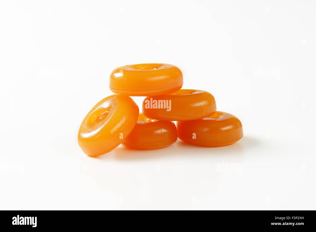 stack of caramel candies on white background Stock Photo - Alamy