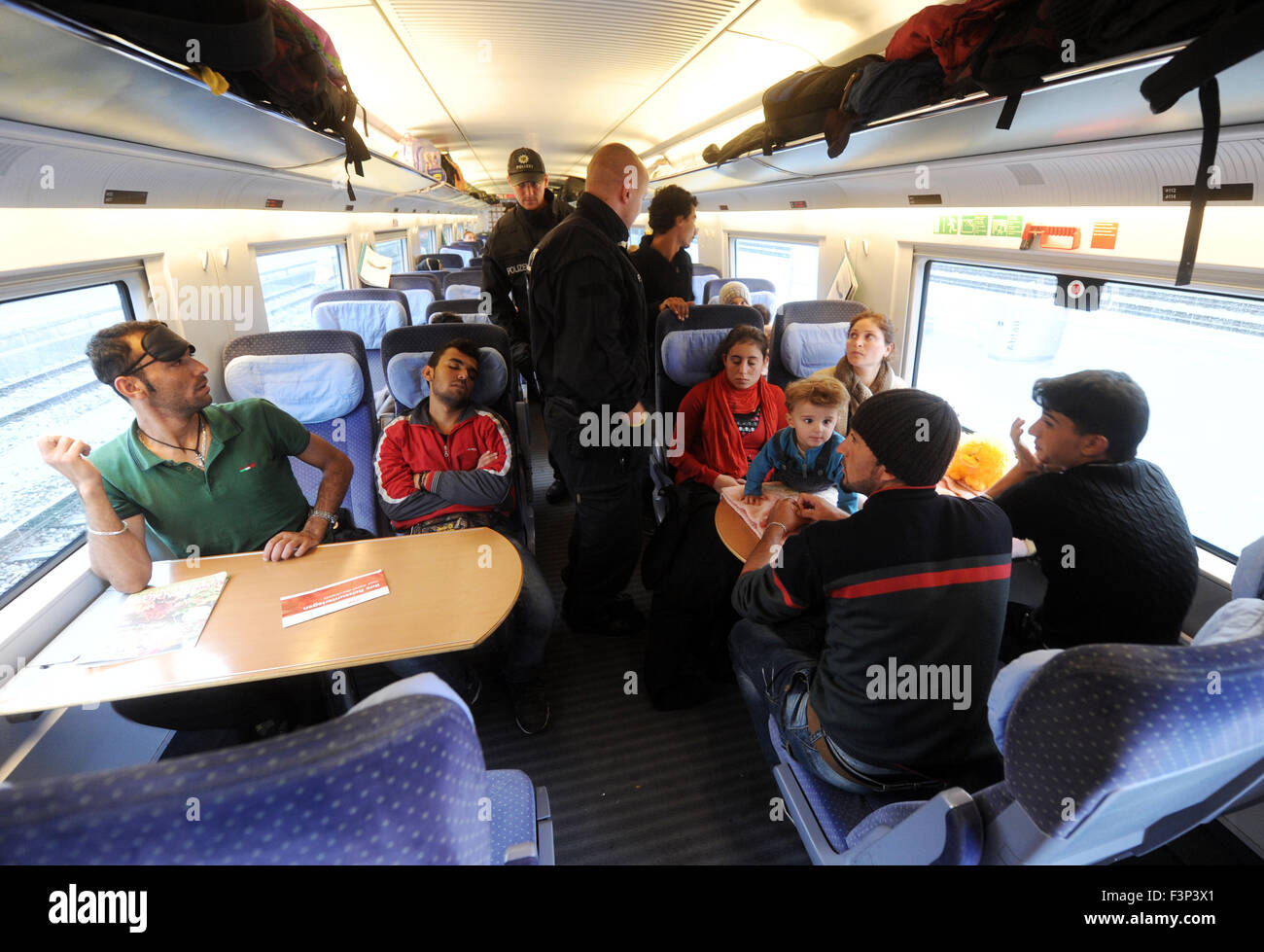 Passau, Germany. 07th Oct, 2015. Police officers (C) demand that ...