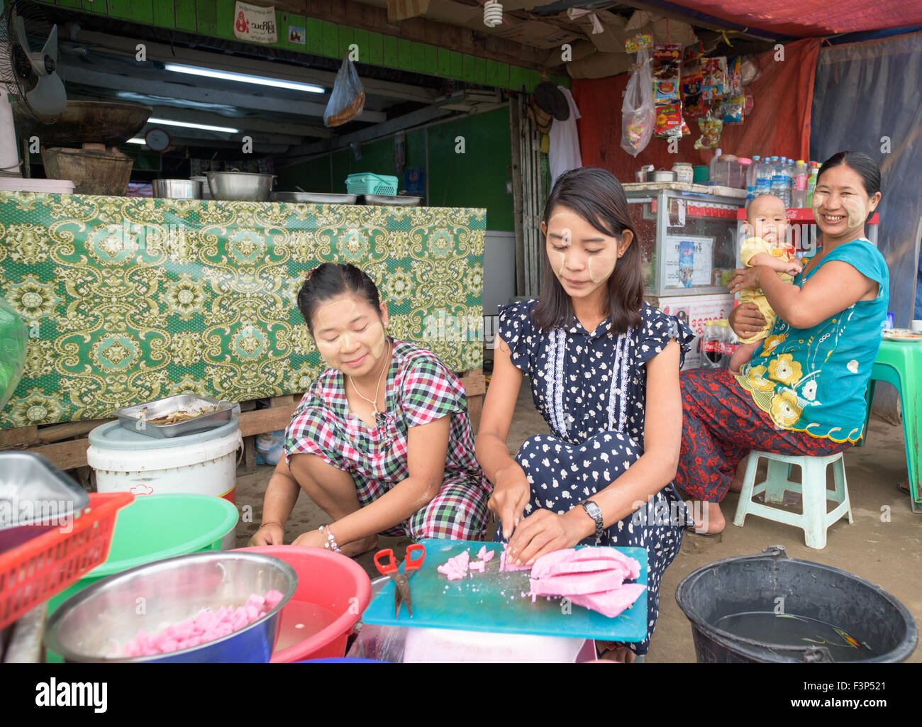 Women preparing food at a local restaurant in Labutta, a township in ...