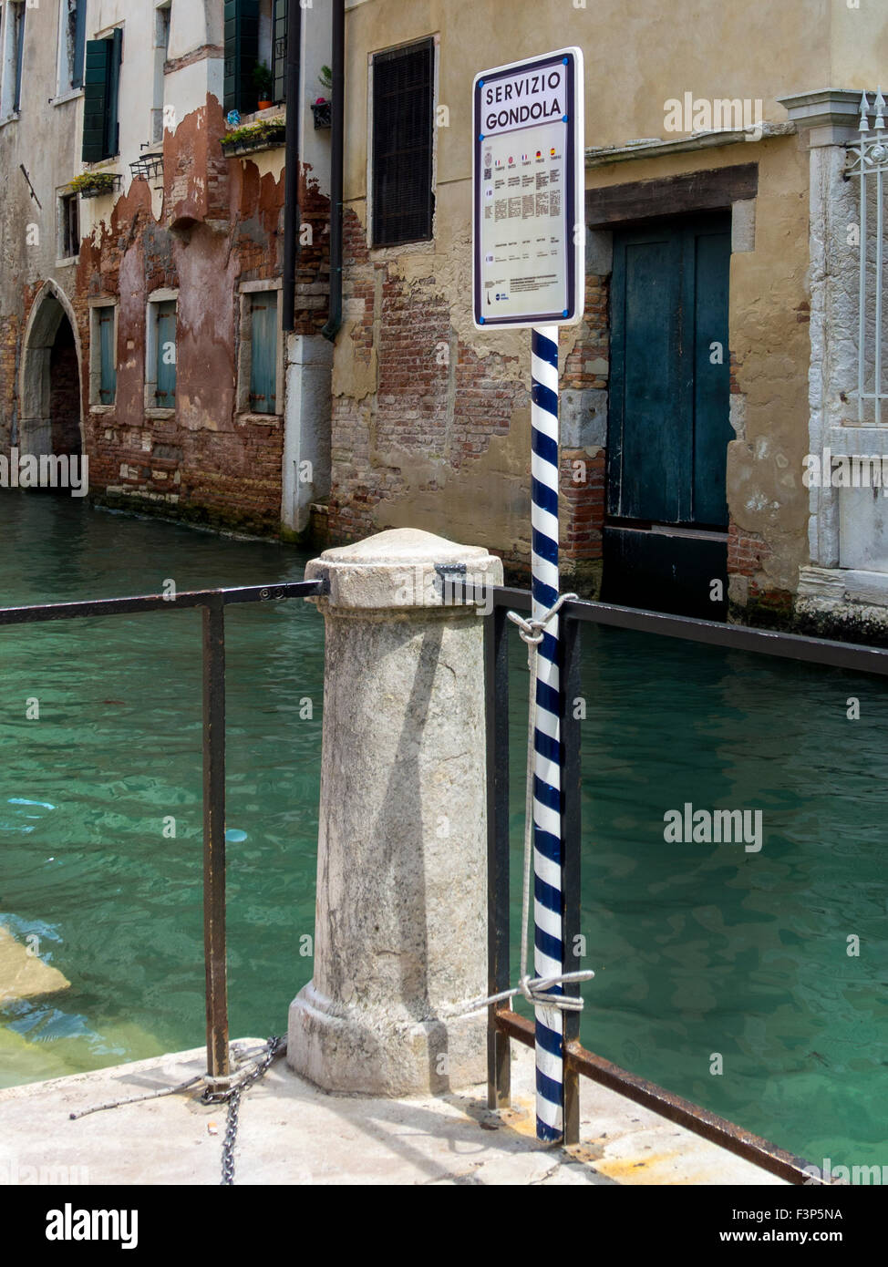 VENICE, ITALY - MAY 05, 2015: Gondola Service sign on small canal with ...