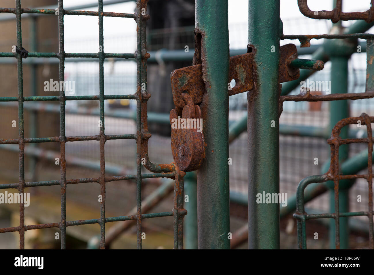 Rusty padlock on an old green rusting metal gate Stock Photo - Alamy